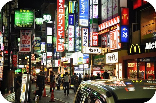 “The roaring street is hung for miles With fierce electric fire ...